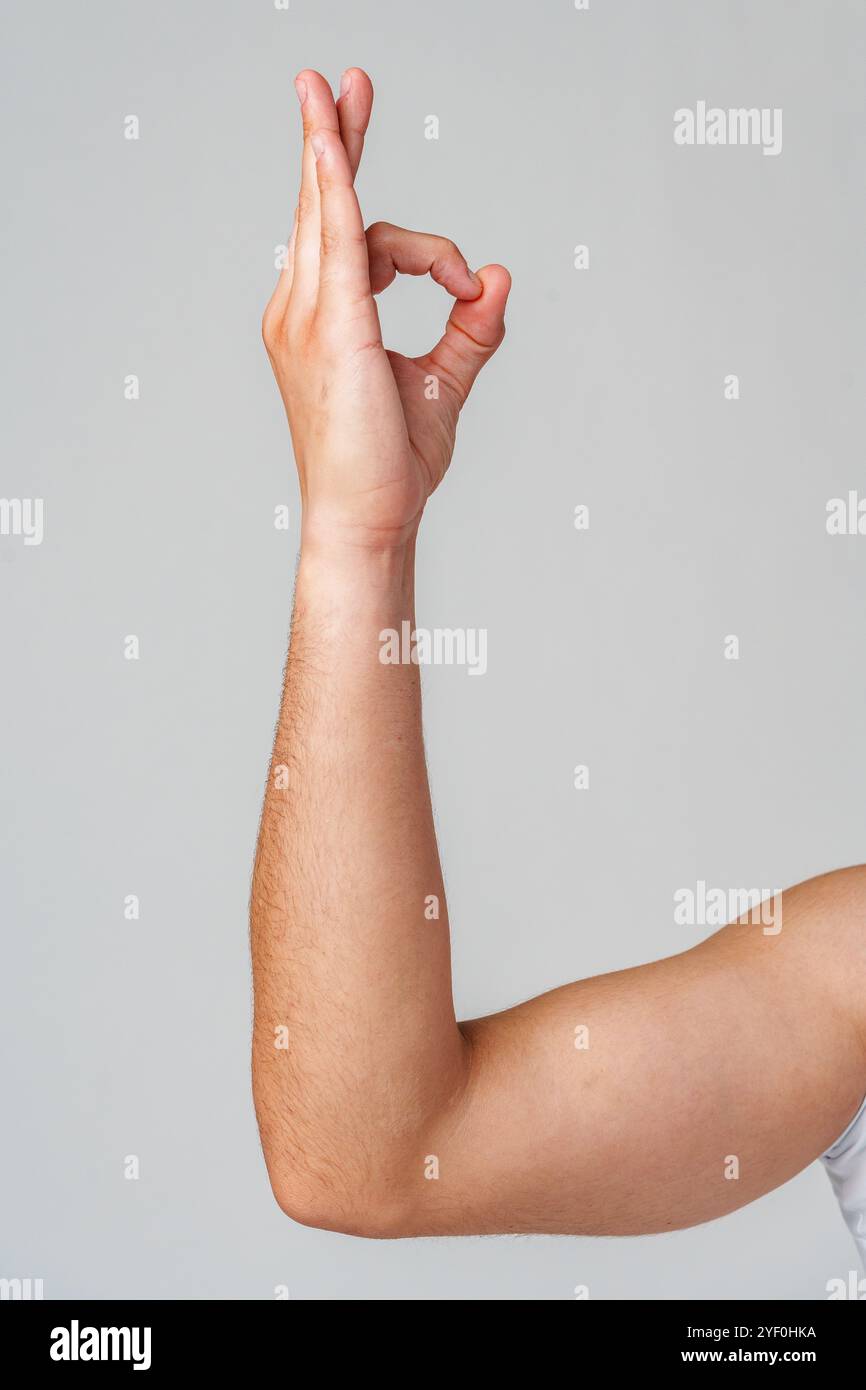 A person hand gesture against a neutral background Stock Photo - Alamy