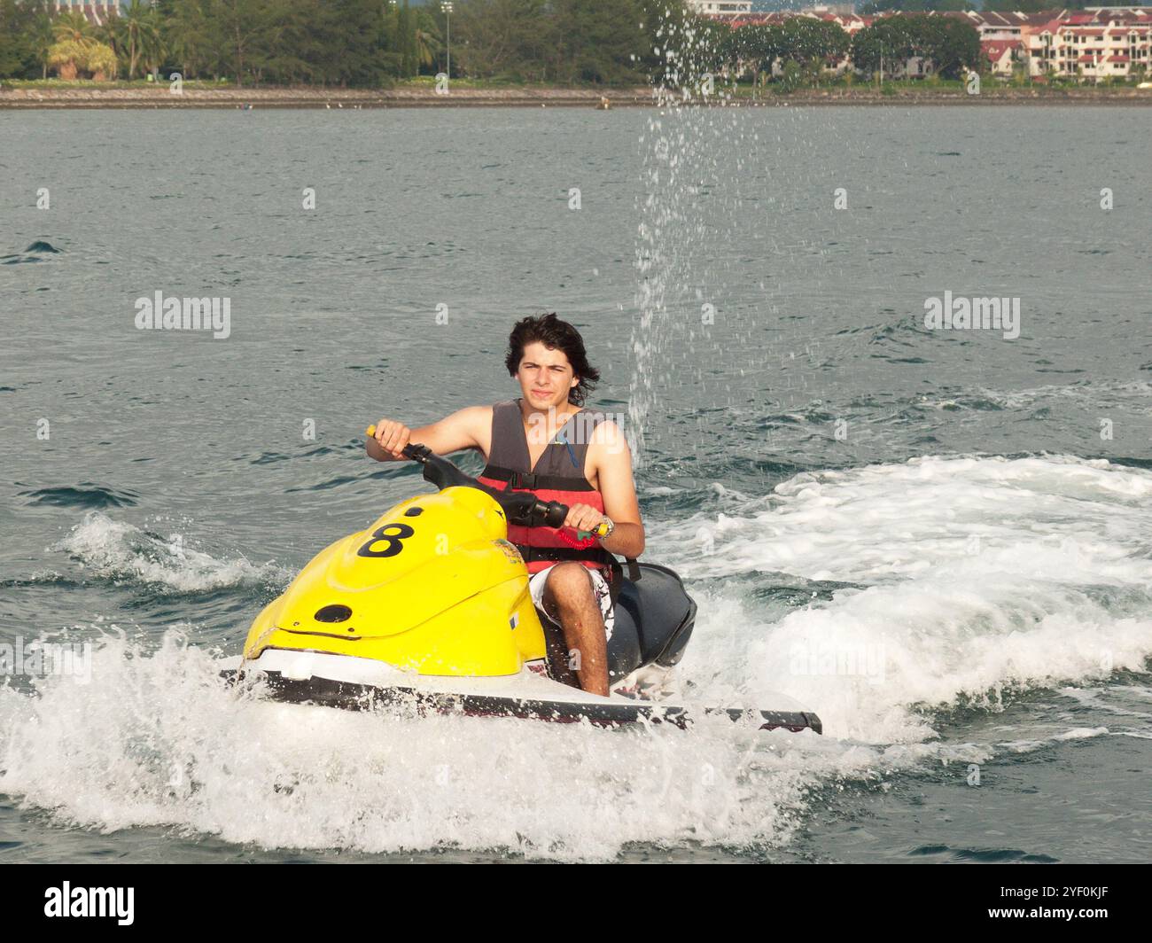 Young man on a jet ski in South China sea, Kota Kinabalu, Borneo ...