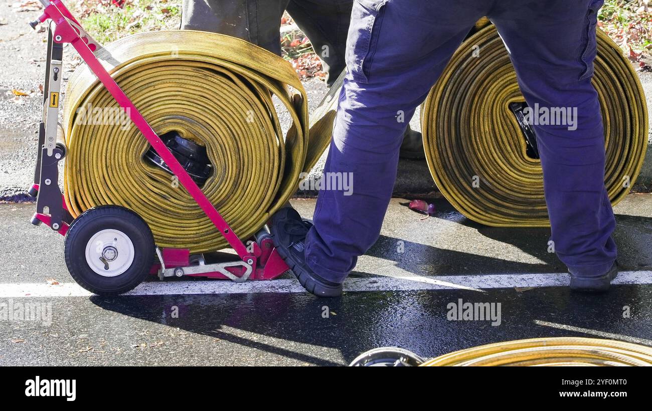 NORWALK, CT, USA - NOVEMBER 1, 2024: A firefighter stands on pavement ...