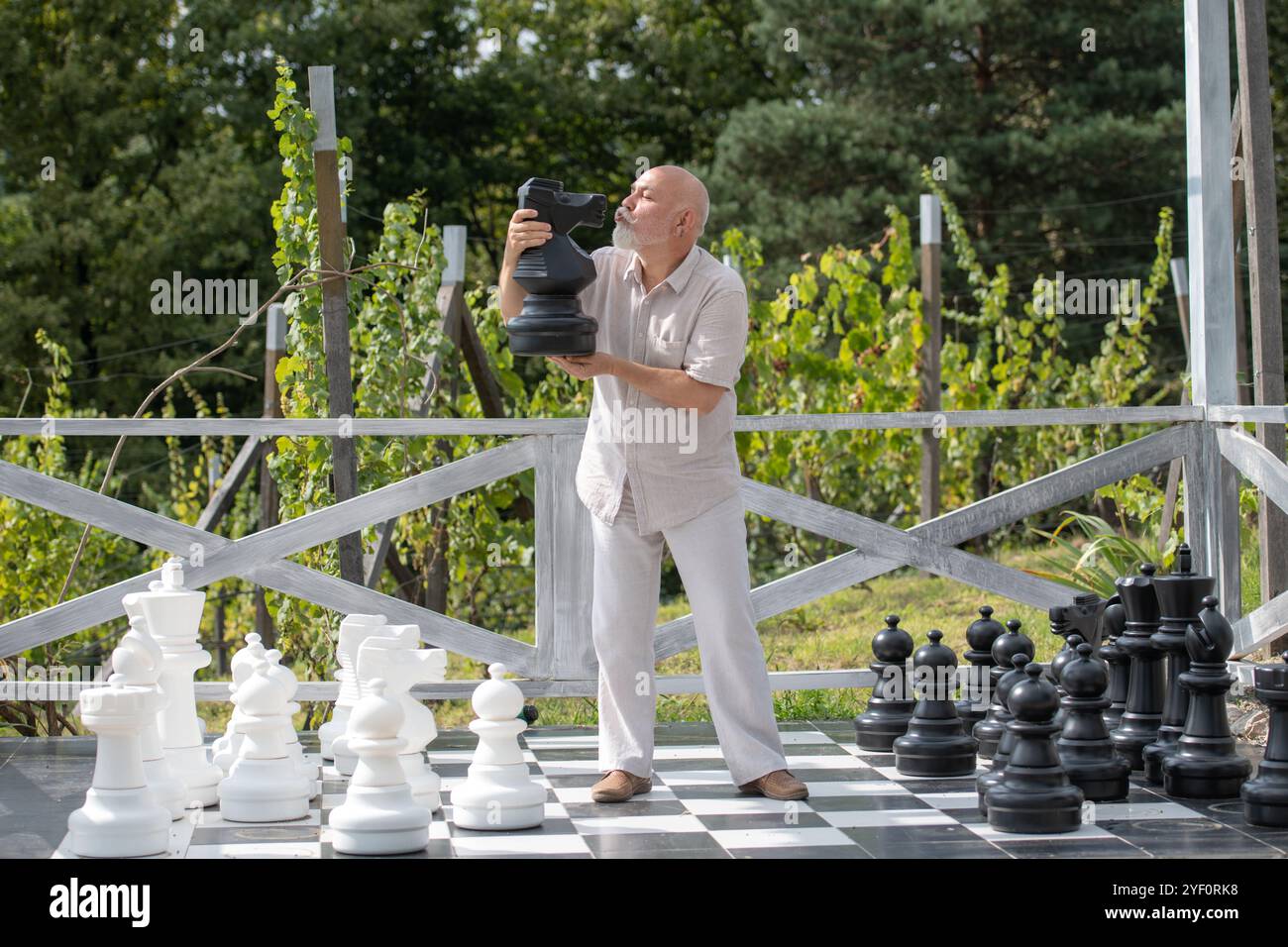Retirement. Senior playing chess on big chessboard in the park. Chess ...