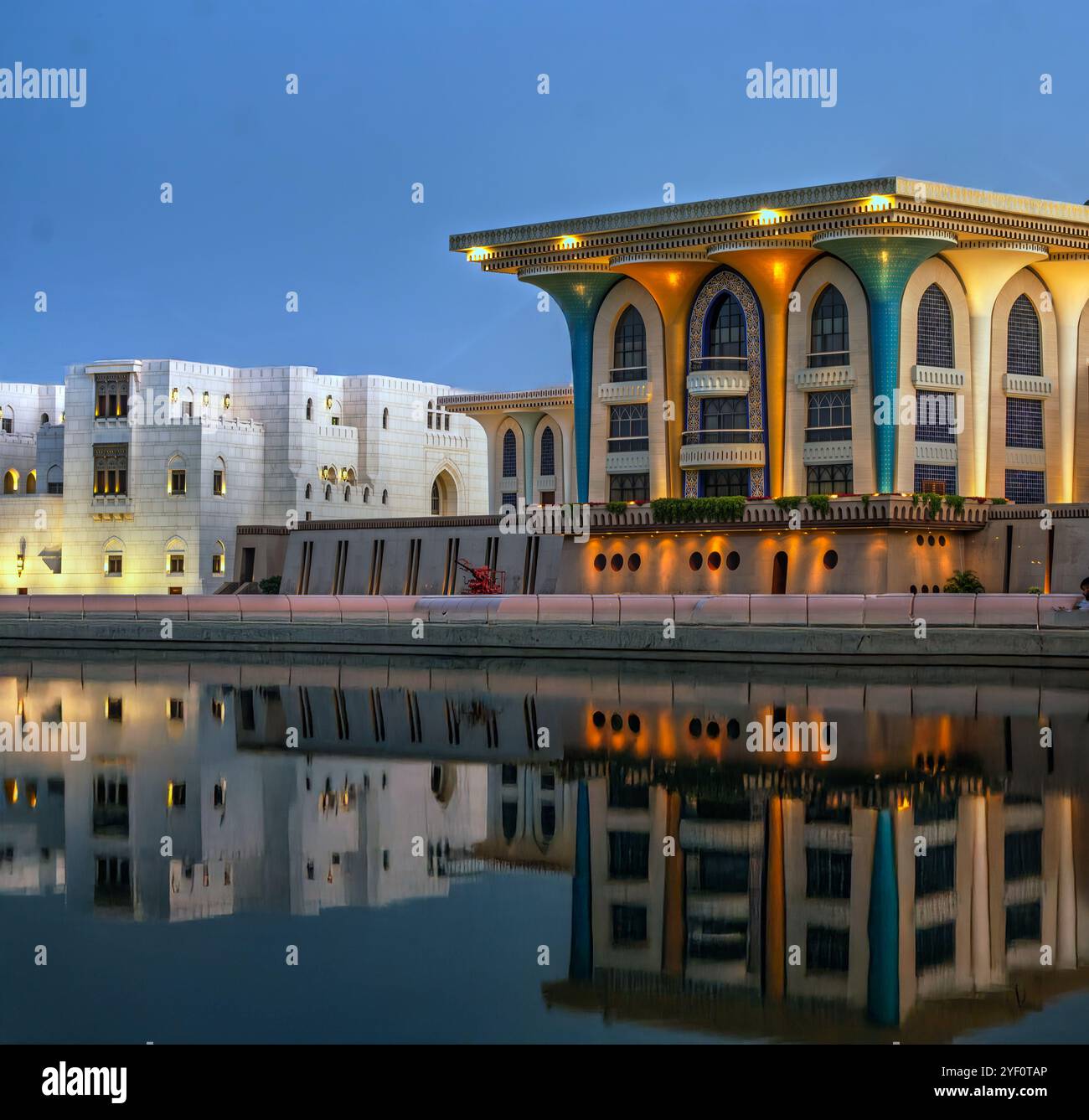 The front gate of Al Alam Palace in Muscat, Oman, reflects on water ...