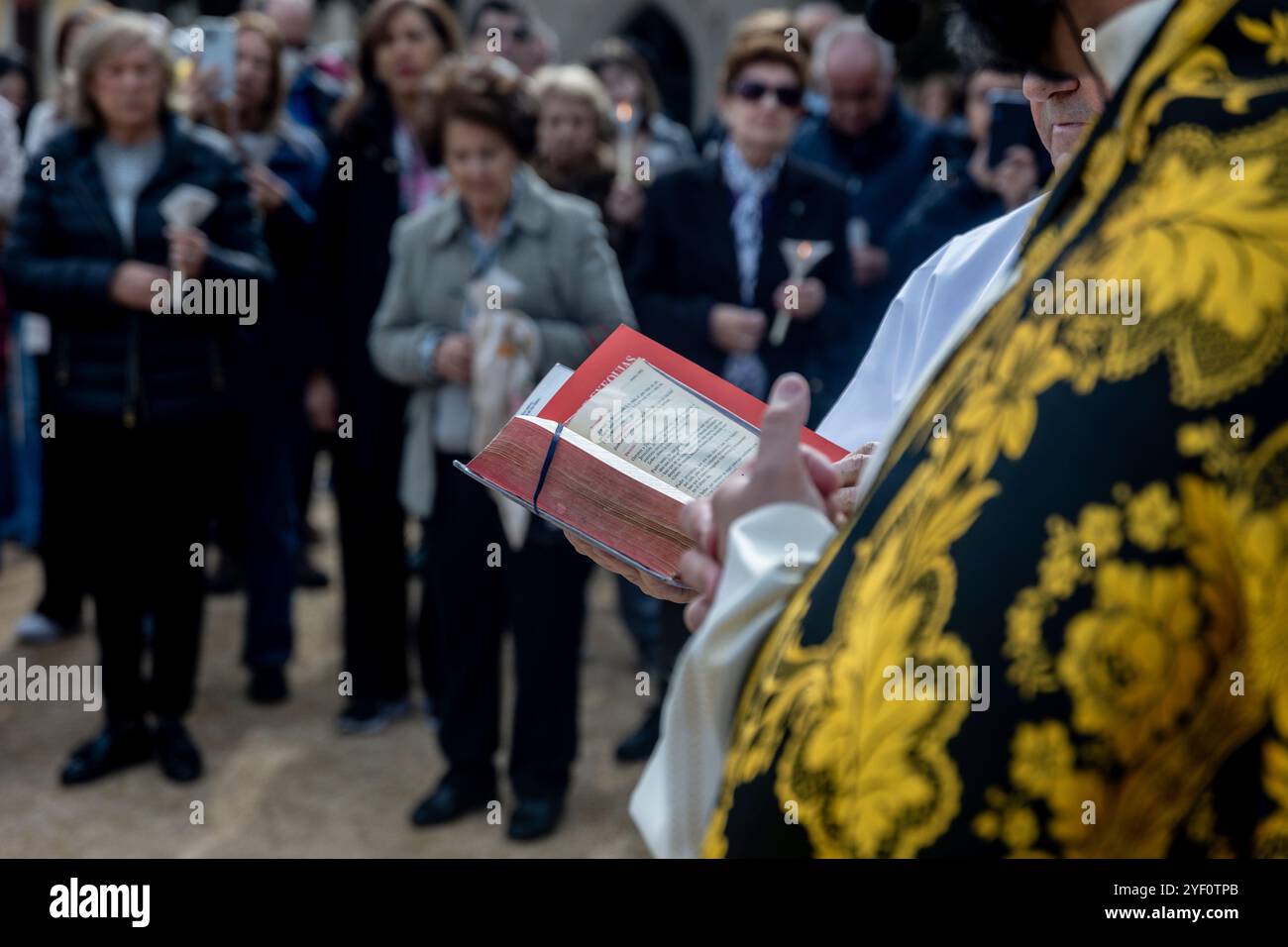 A priest reads the Bible during the Procession for the Faithful ...