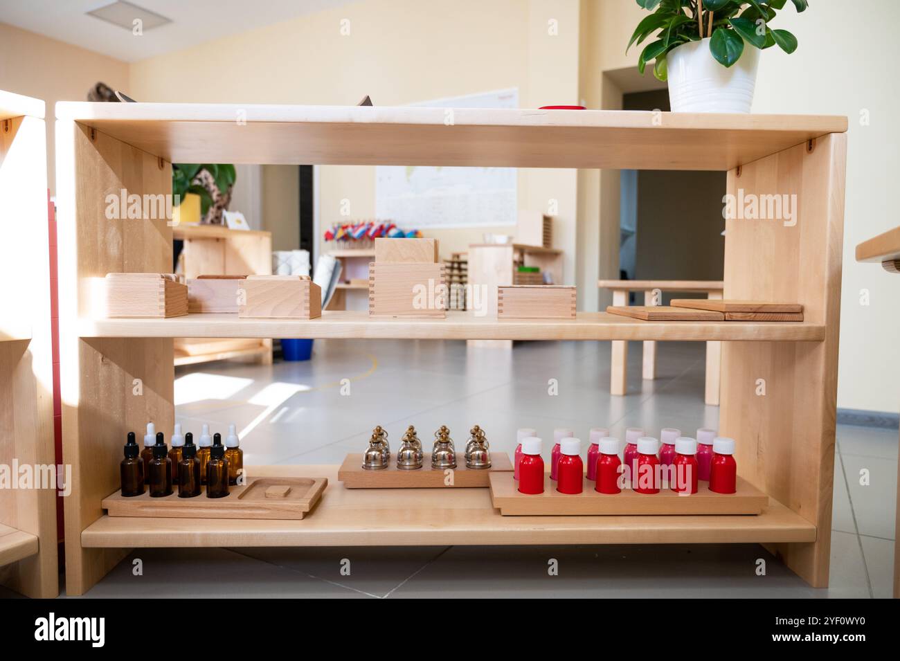Organized Montessori classroom shelf featuring educational materials ...