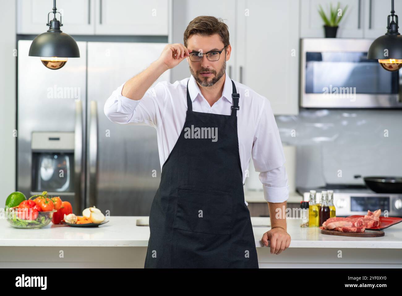 Chef on kitchen. Professional chef man in uniform on kitchen. Bearded ...