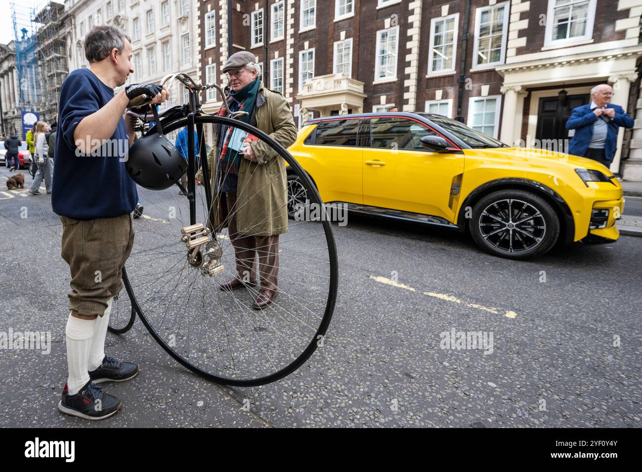 London, UK. 2 November 2024. A Penny Farthing rider and a Renault 5 ...