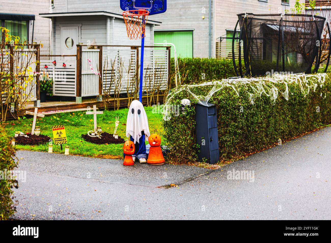 Halloween ghost decoration with pumpkins, fake graves, cobwebs, and ...