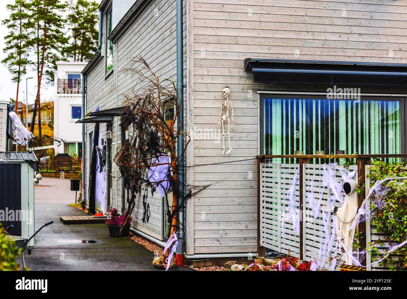 Halloween decorations on house wall with skeleton, ghostly figures ...