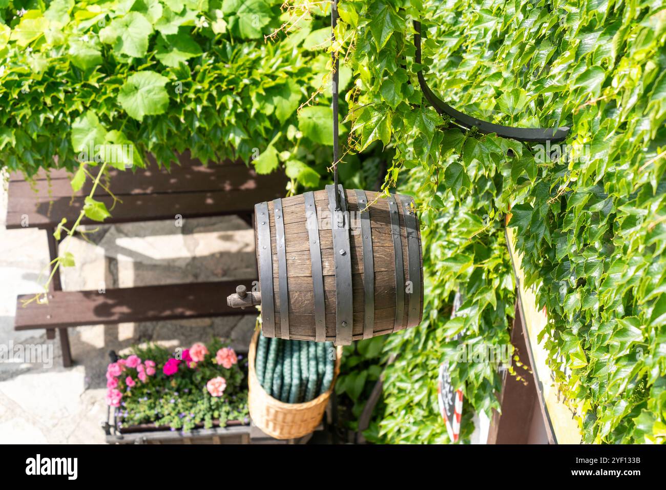 Wooden barrel sign hanging on the wall of an old country house ...