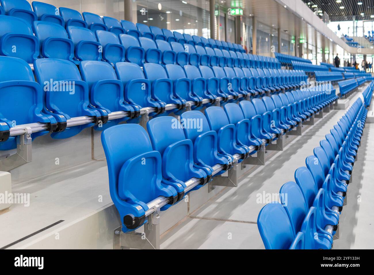 A long row of modern blue chairs with folding seats in a hall Stock ...