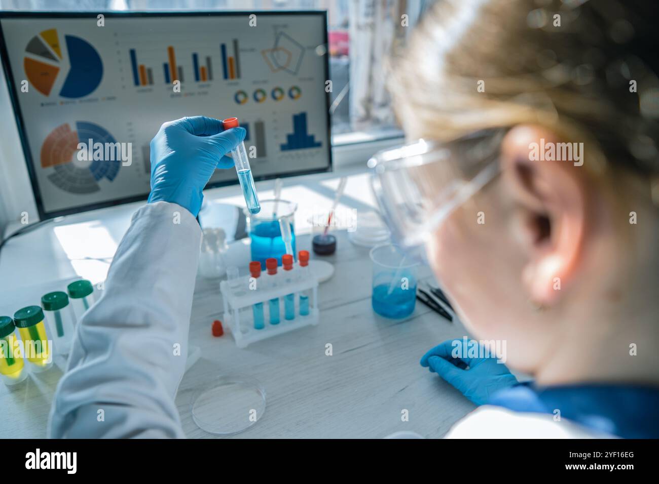 Scientist conducting experiment colorful chemicals hi-res stock ...