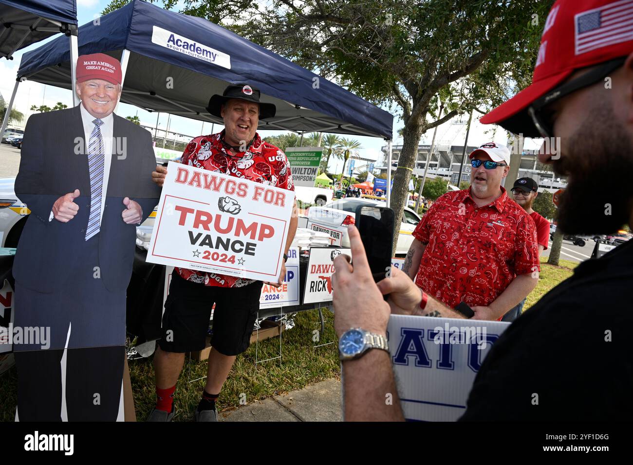 Georgia fans pose for photos next to the likeness of Republican ...