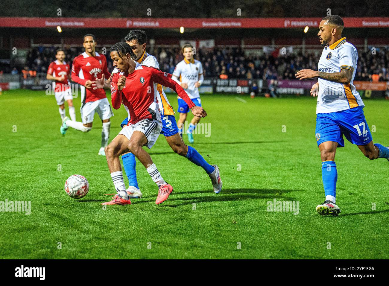 Kyrell Malcolm of Salford City FC under pressure from Shrewsbury Town ...