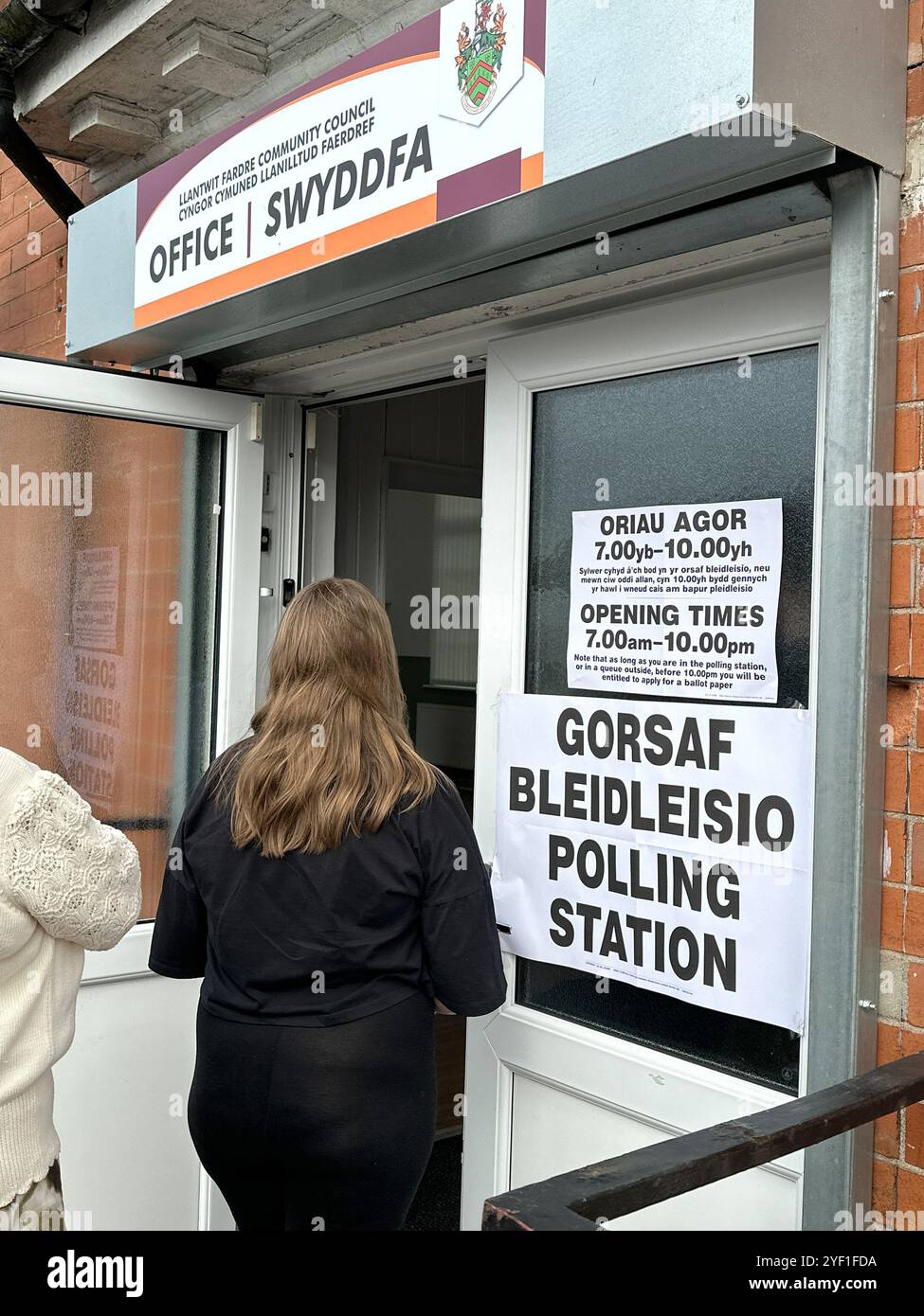 Church Village, Pontypridd, Wales, UK - 4 July 2024: People queuing to ...