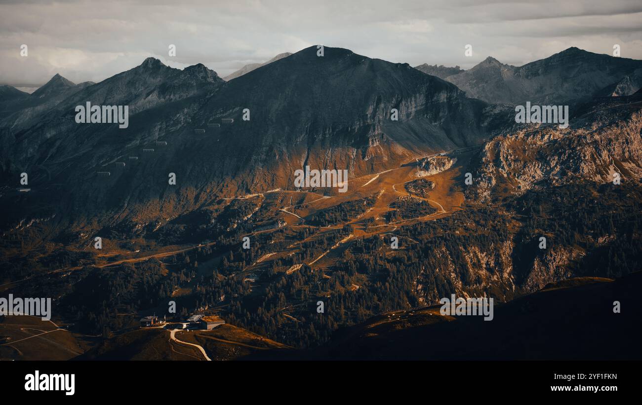 A beautiful mountain, lushly covered in trees, stands majestically with ...