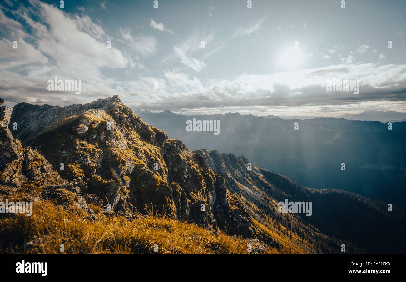 The brilliant sun is shining brightly through the fluffy clouds that ...