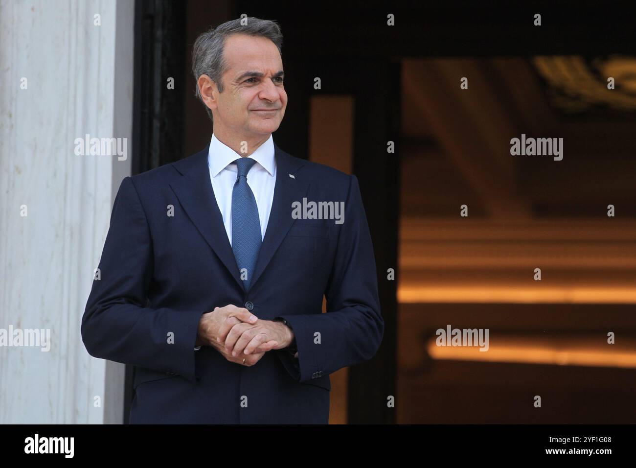 Greek Prime Minister Kyriakos Mitsotakis stands at Maximos Mansion in ...