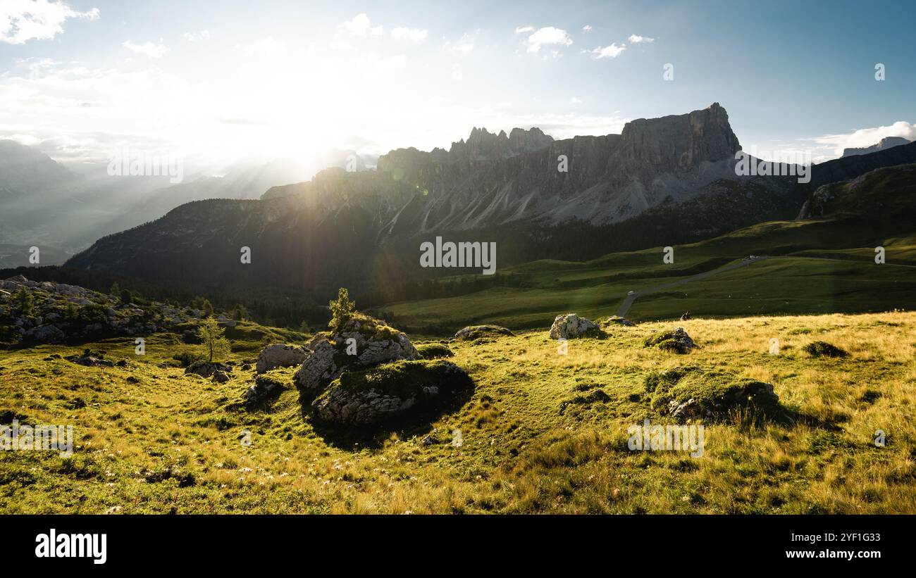 The warm sun is shining brightly through the fluffy clouds that are ...