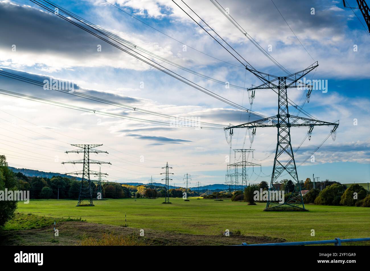 A landscape photo of power lines and transmission towers stretching ...