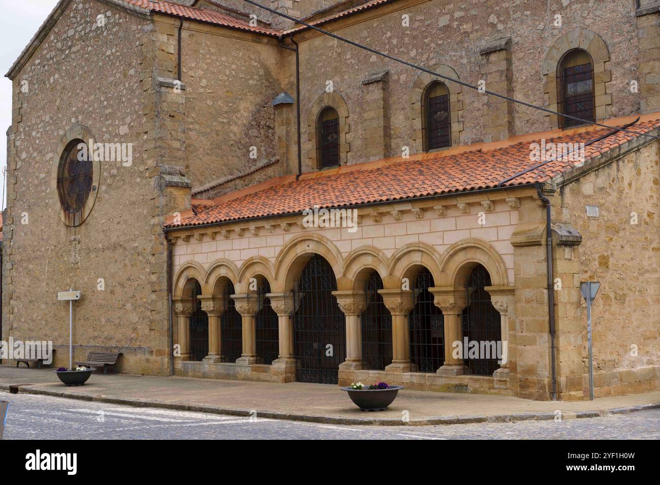 A historic stone building featuring Romanesque architecture with arched ...