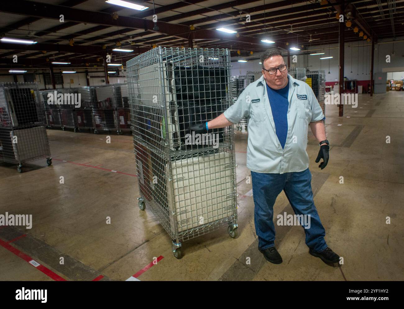 County worker Bill Dalessandro pulls a cage loaded with a voting machine as they prepare to ship ...