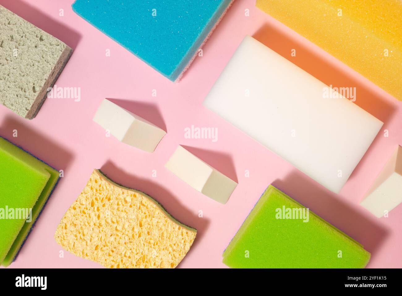 Creative arrangement from cleaning sponges on pastel pink background ...
