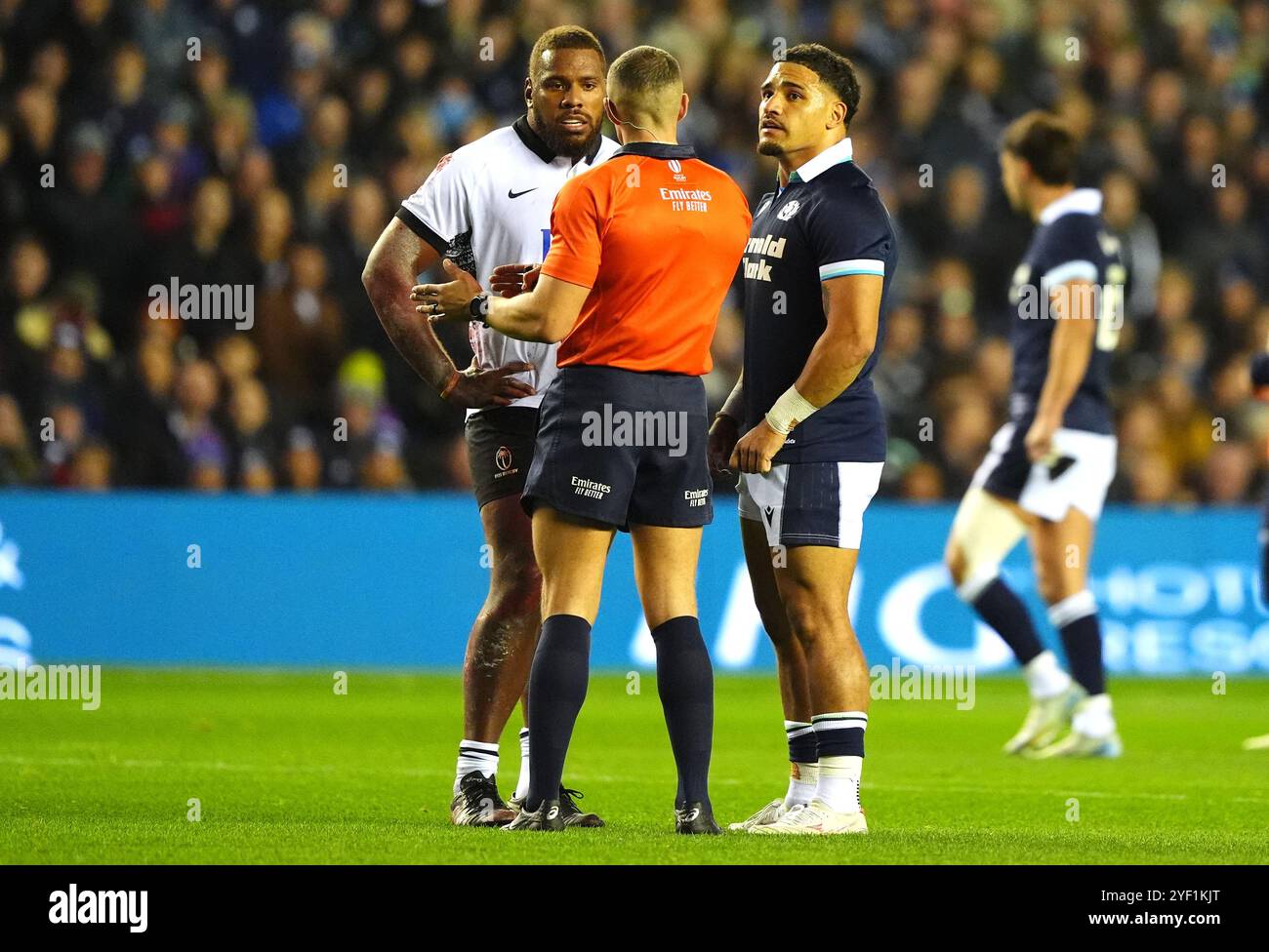 Referee Craig Evans (centre) speaks to the Scotland and Fiji captains ...