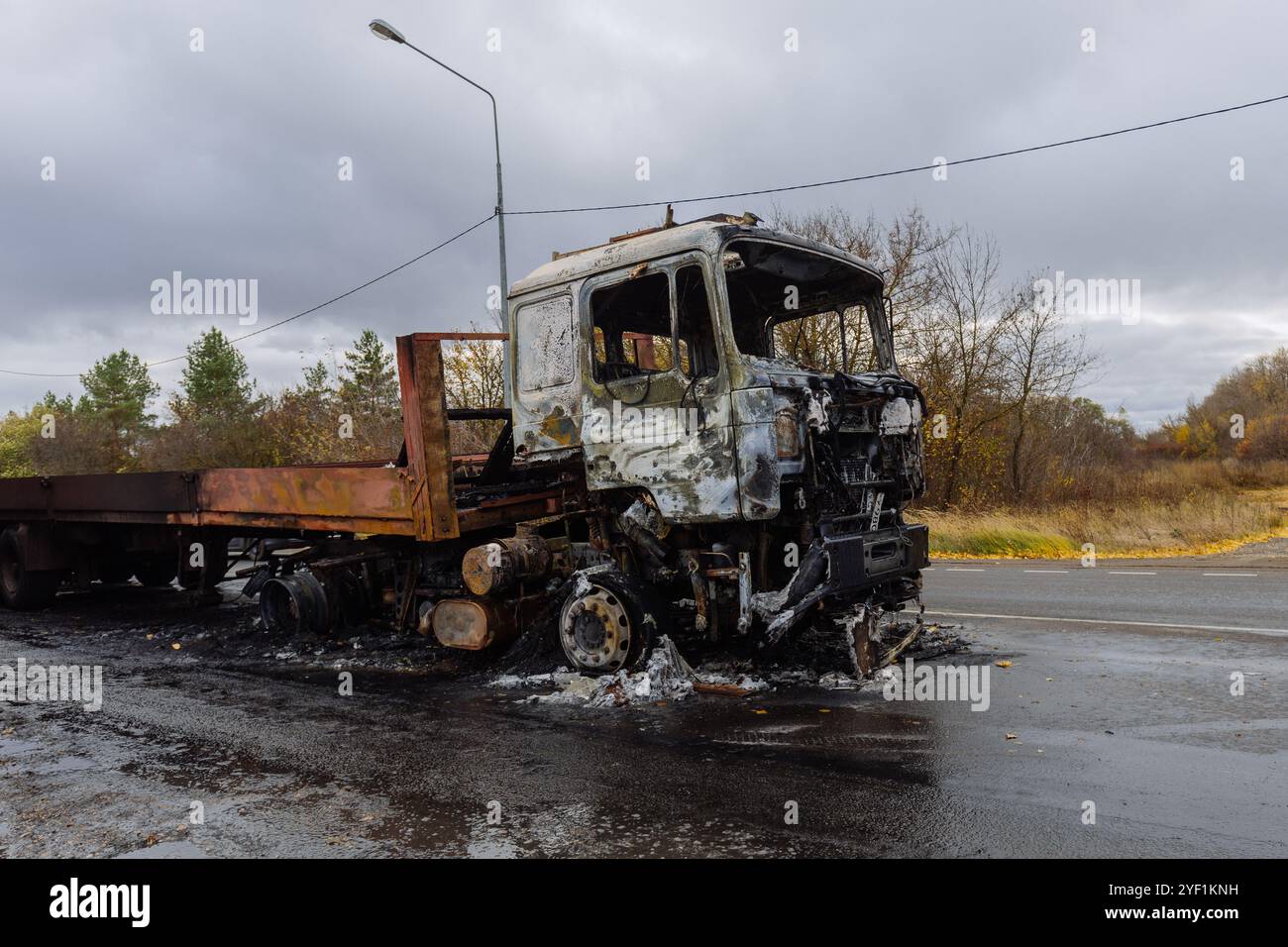 Burnt truck on the road. Fire or attack aftermath Stock Photo - Alamy