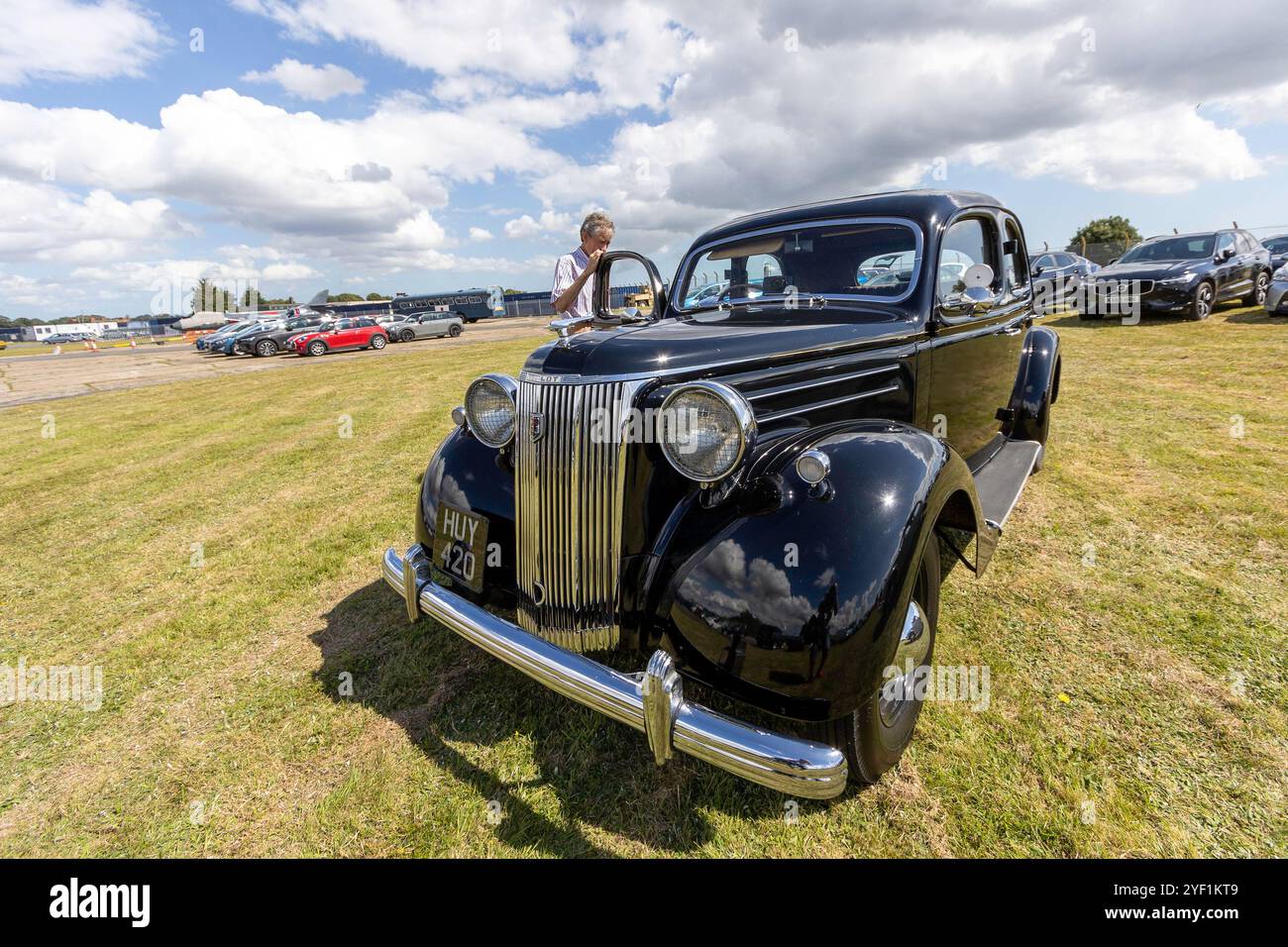 On a sunny day a beautifully presented shiny black Ford V8 Pilot at a ...