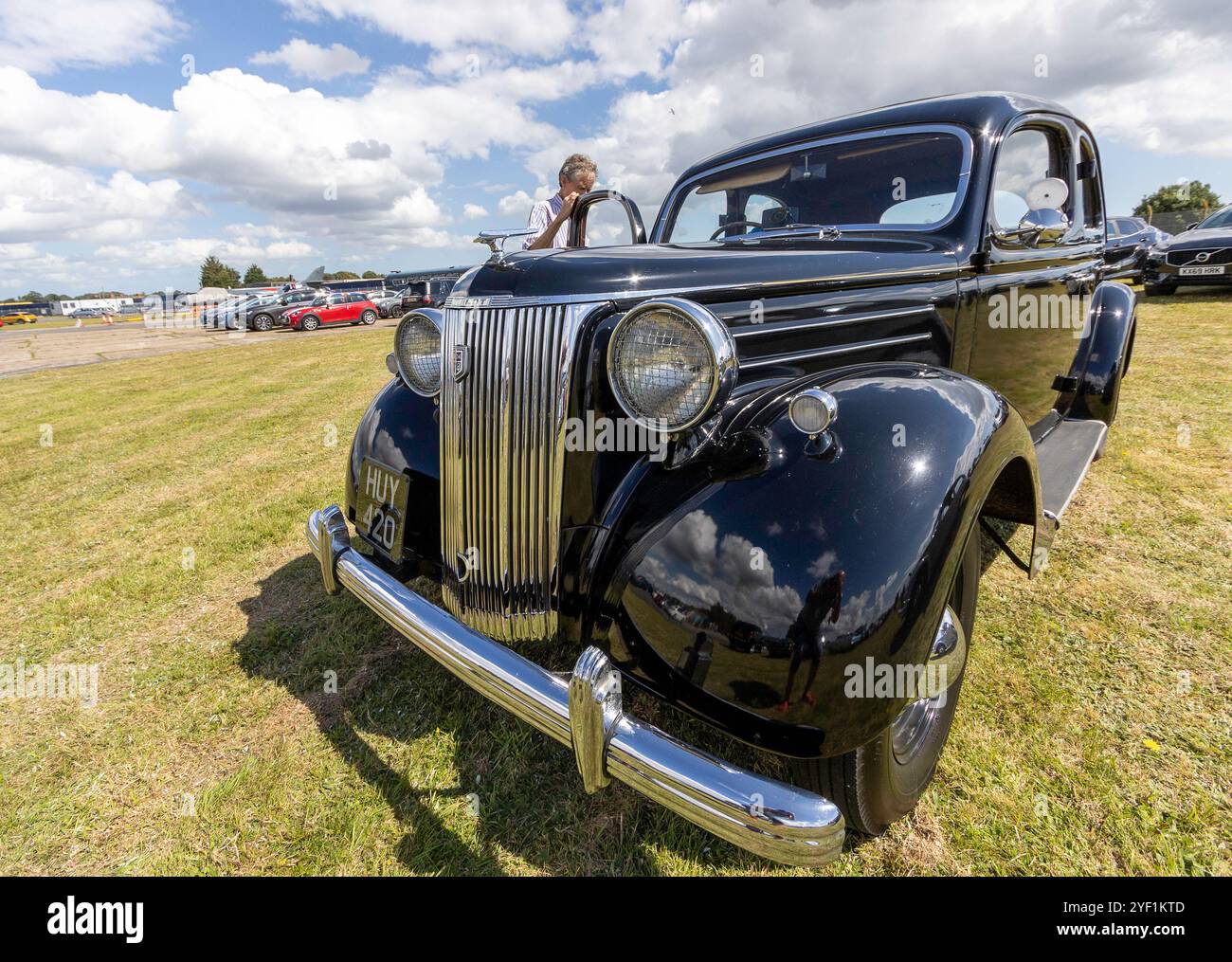 On a sunny day a beautifully presented shiny black Ford V8 Pilot at a ...