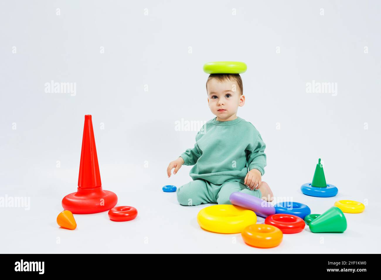 Little boy playing logic educational games with plastic pyramid ...