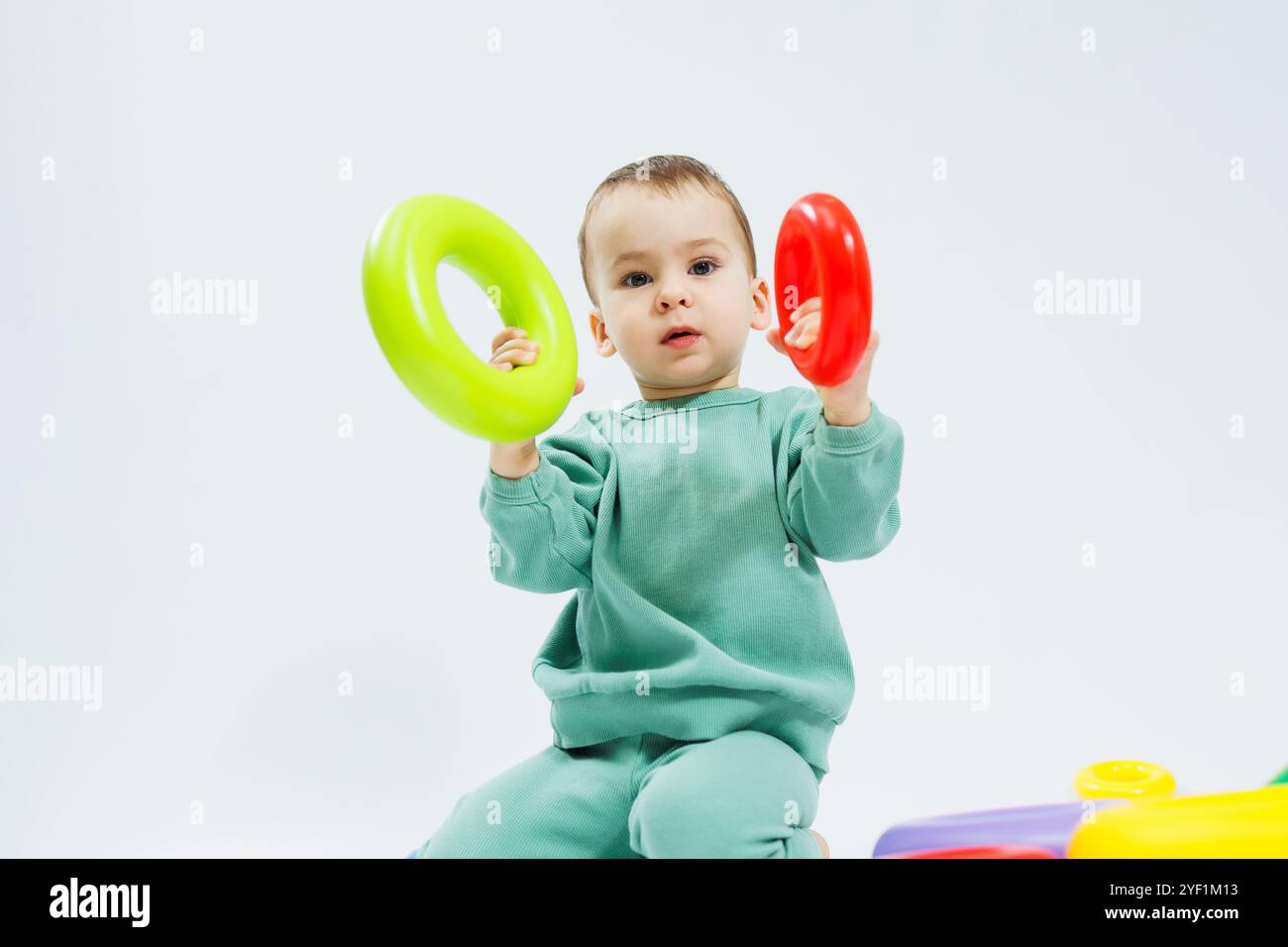 Little boy playing logic educational games with plastic pyramid ...