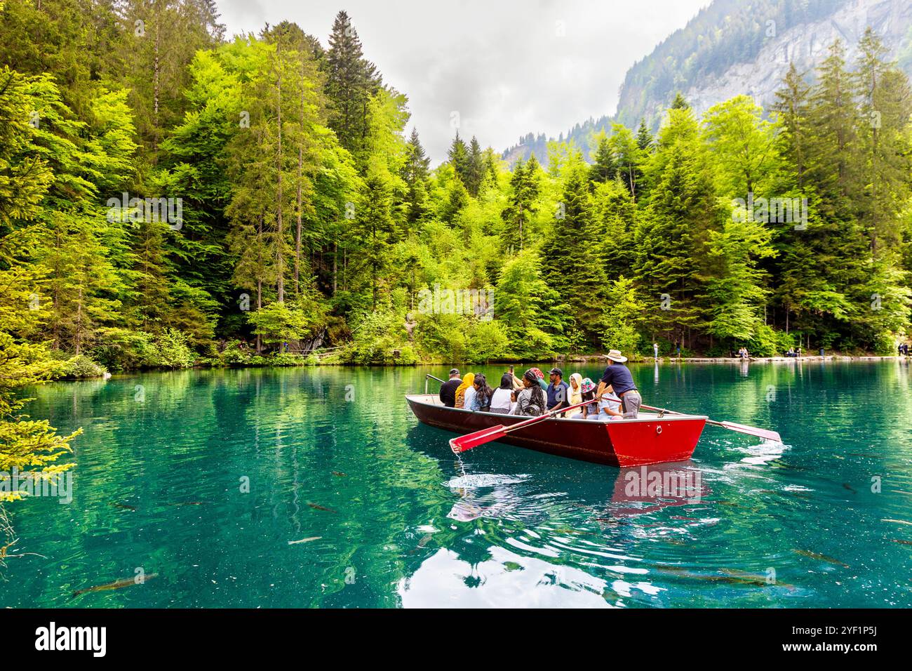 Tourists taking a boat ride on Blausee Lake (Blue Lake), Switzerland ...