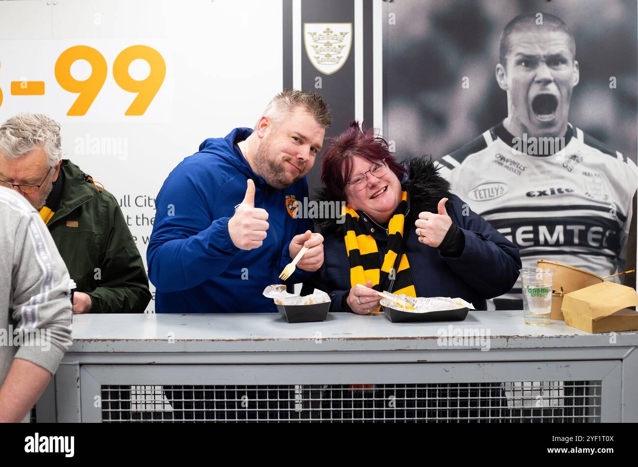 Supporters on the concourse eating food before kick-off at Hull City ...