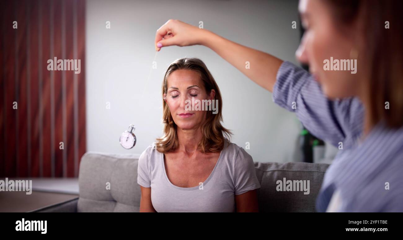 Woman Hypnotized By Watch. Hypnotherapy And Mind Control Stock Photo ...