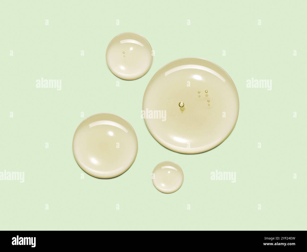 Yellow serum oil sample swatch round shape texture isolated on pastel ...