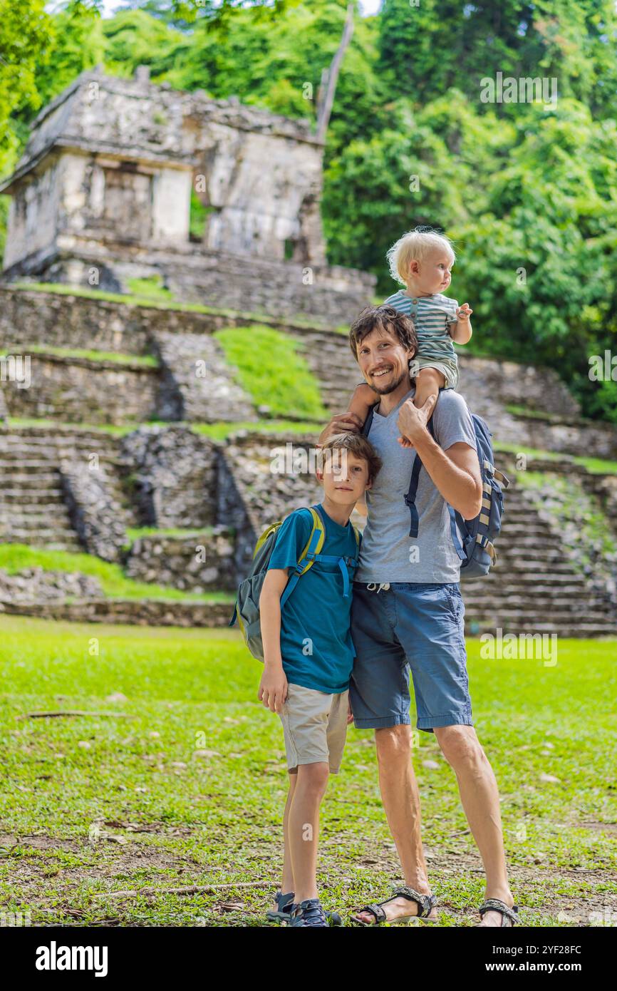 Father with his toddler and teenage sons exploring the ancient pyramids ...