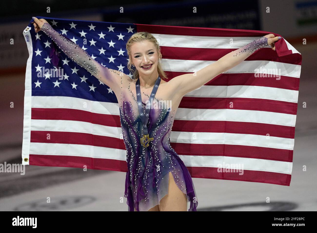 Amber Glenn, of the United States, poses after winning the gold medal ...