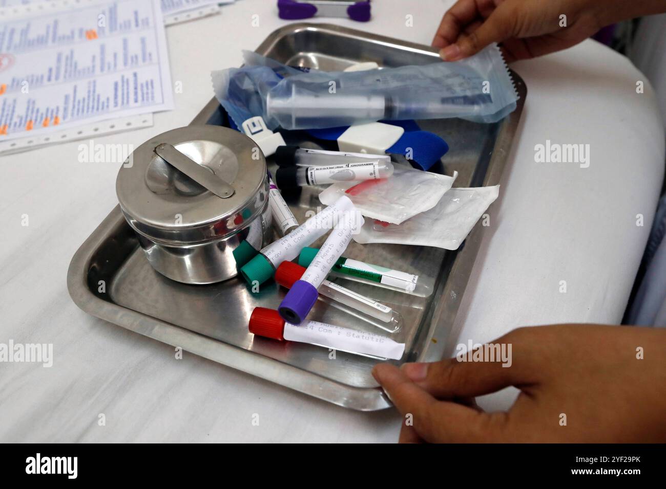 Calmette hospital. Nurse taking blood sample from a young boy. Phnom ...