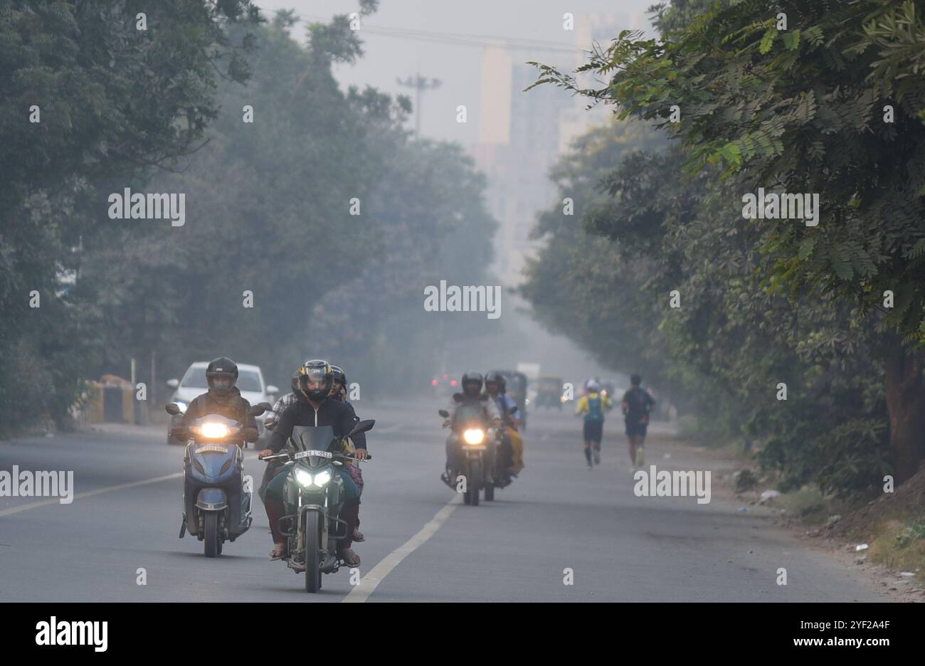 GURUGRAM, INDIA - NOVEMBER 2: People going to work and a thick layer of ...