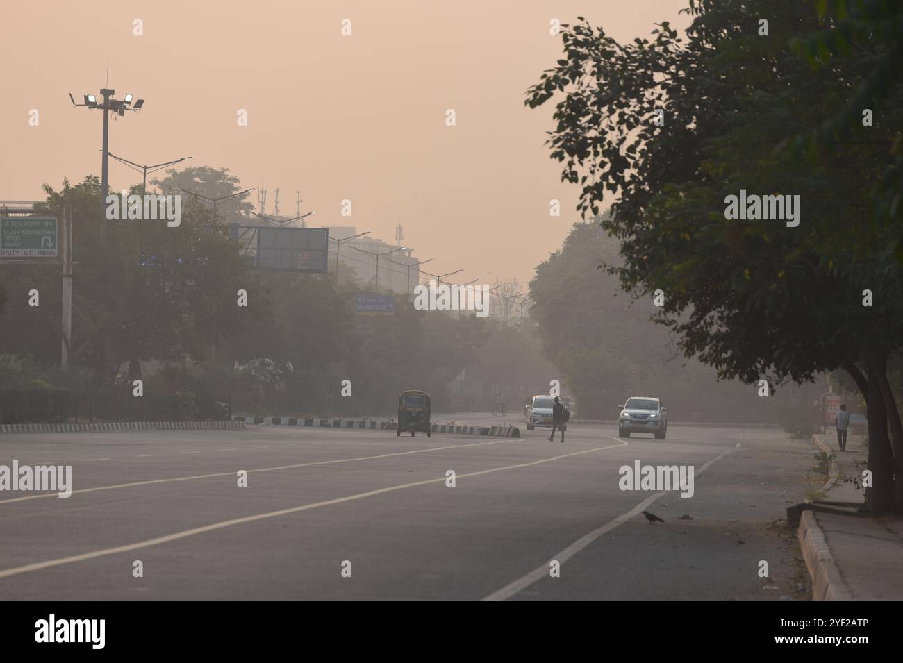 GURUGRAM, INDIA - NOVEMBER 2: People going to work and a thick layer of ...