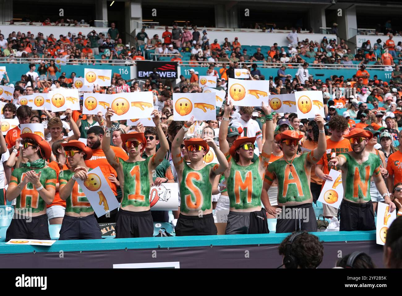 Miami fans wear body paint during the first half of an NCAA college ...