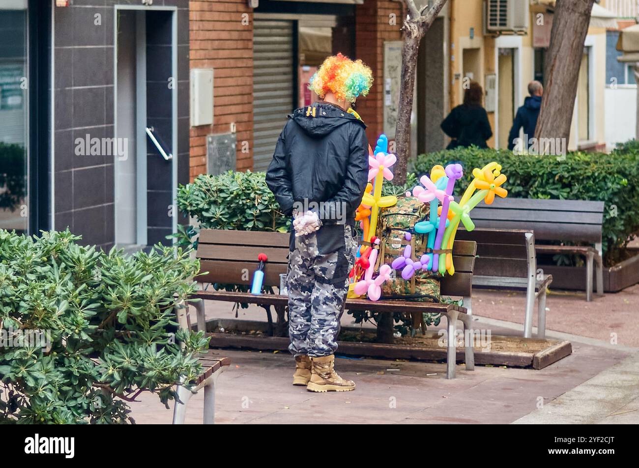 Unrecognizable clown with his back turned, looking worried and with his ...