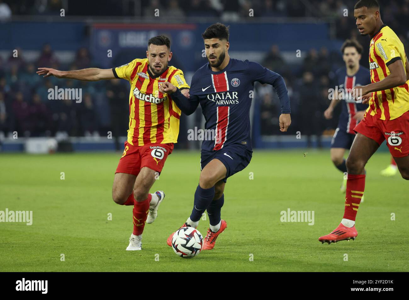 Marco Asensio of PSG, left Adrien Thomasson of Lens during the French ...