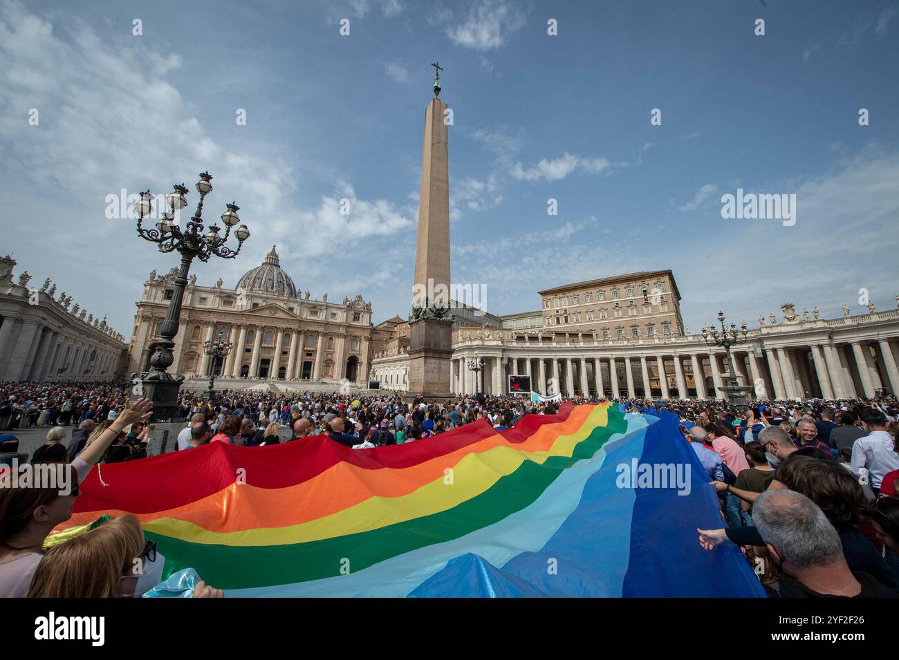 Children hold a rainbow flag as Pope Francis speaks to the crowd during ...
