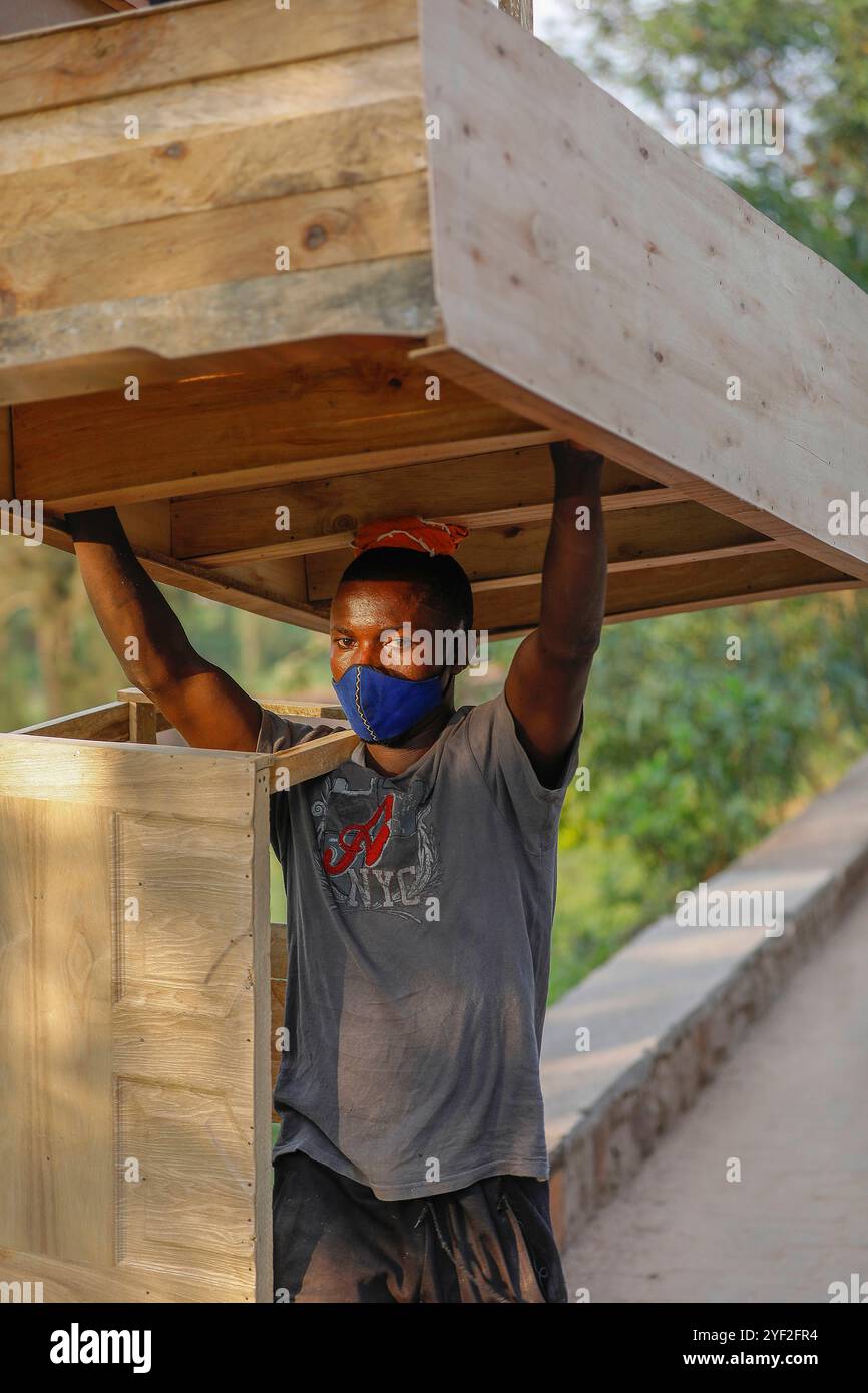 Man carrying furniture in Kigali, Rwanda Man carrying furniture in ...