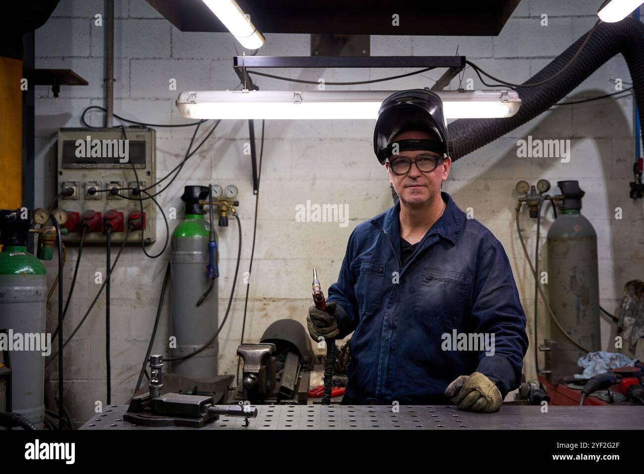 Metalworker assembling custom mechanical parts in metallurgy fabric ...