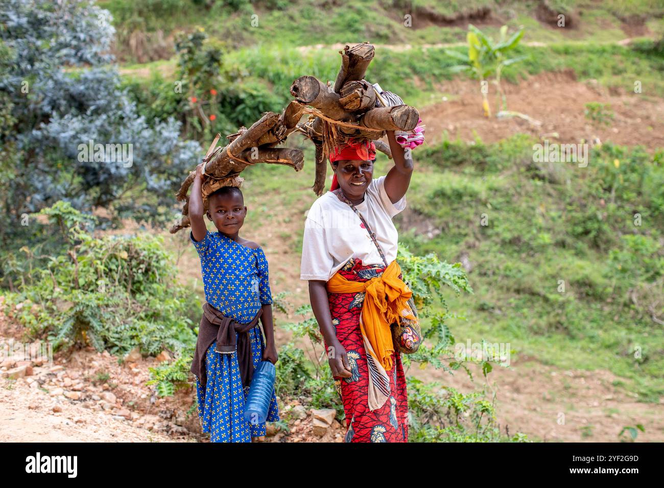 Mother and daughter carrying firewood in western Rwanda Mother and ...