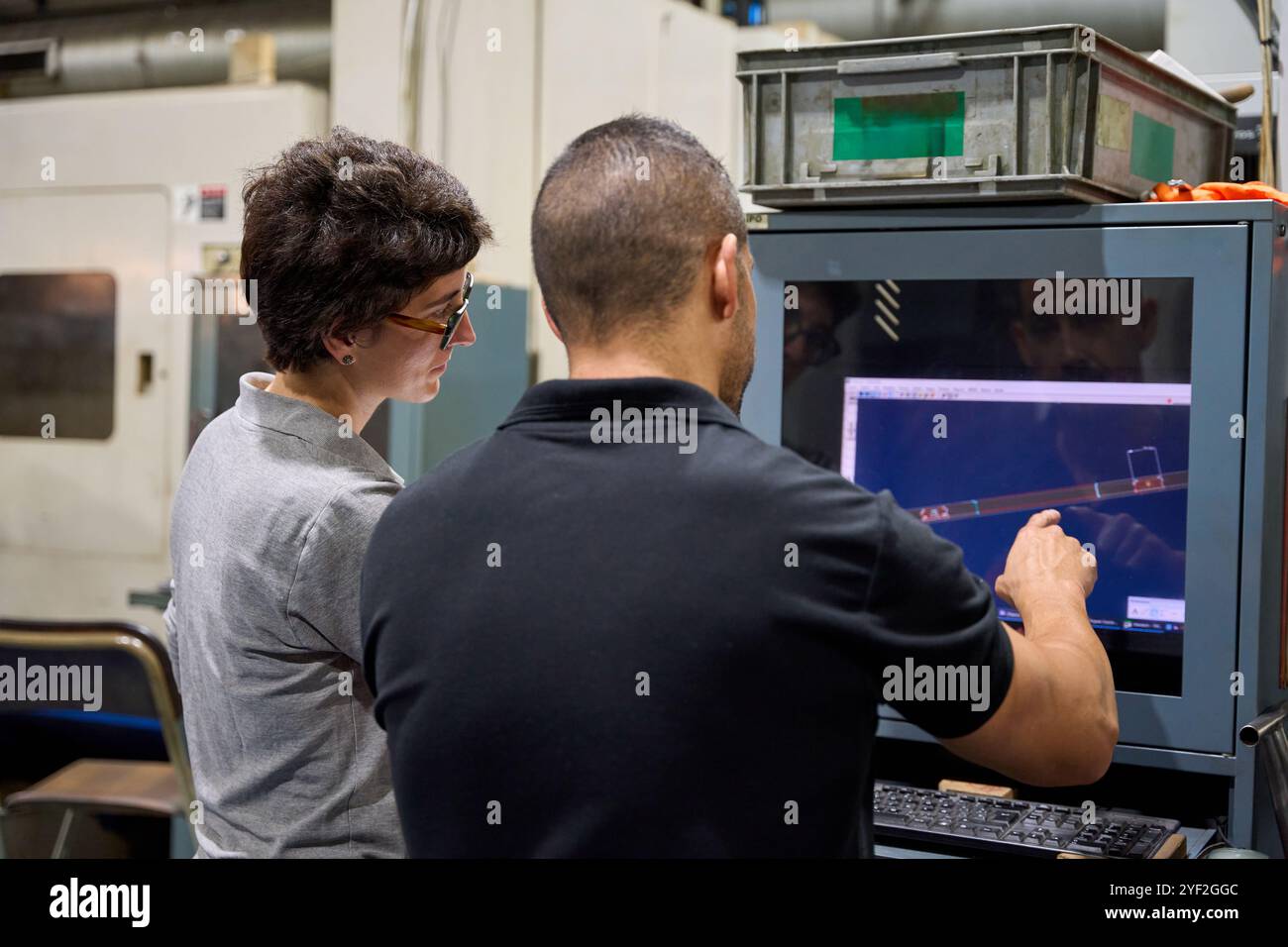 Smiling workers walking and talking in a factory Stock Photo - Alamy