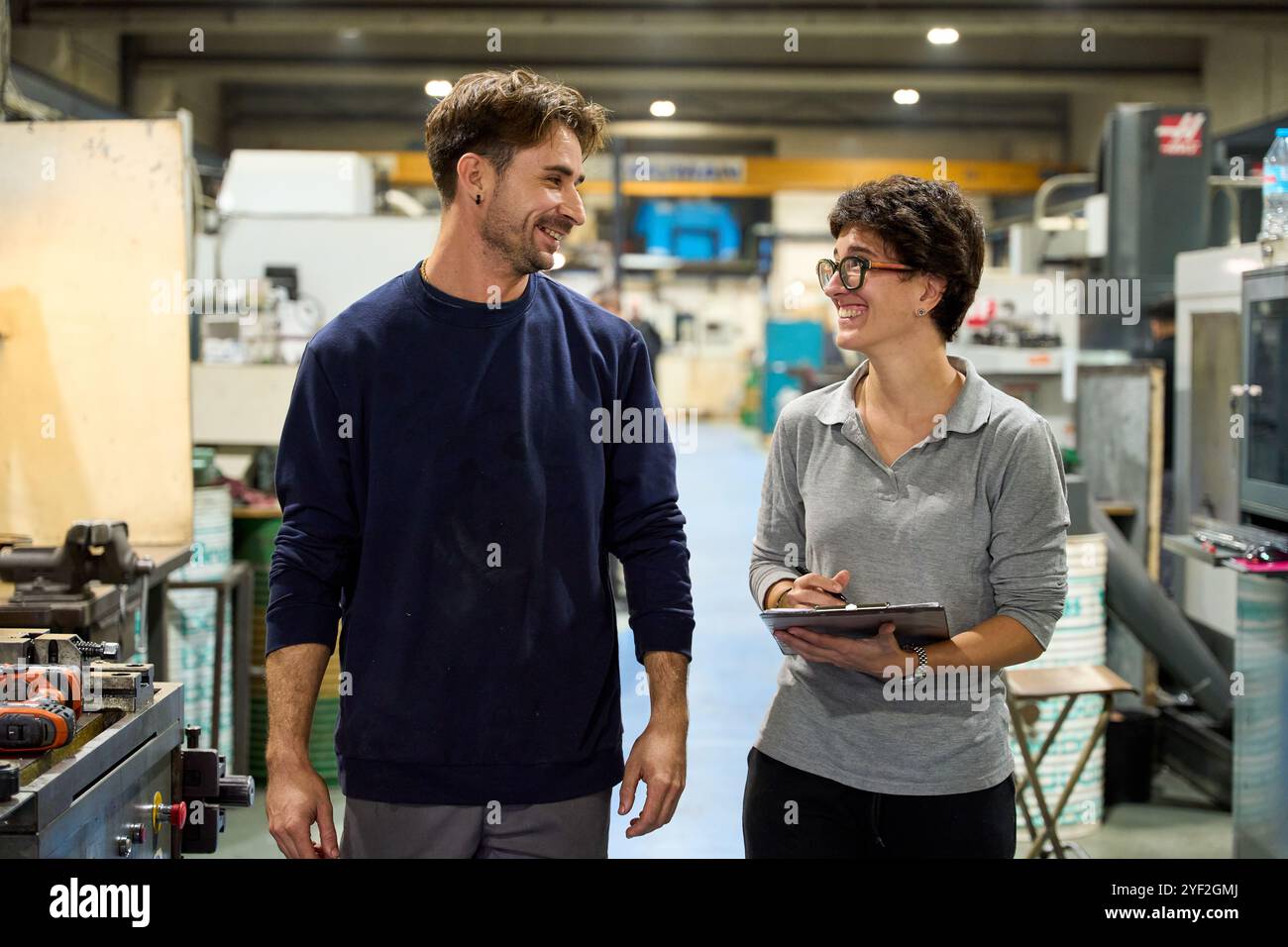 Metalworker checking inventory of steel parts in factory Stock Photo ...