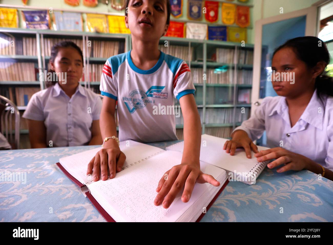 Center for blind children. Blind girls reading braille book Ho Chi Minh ...